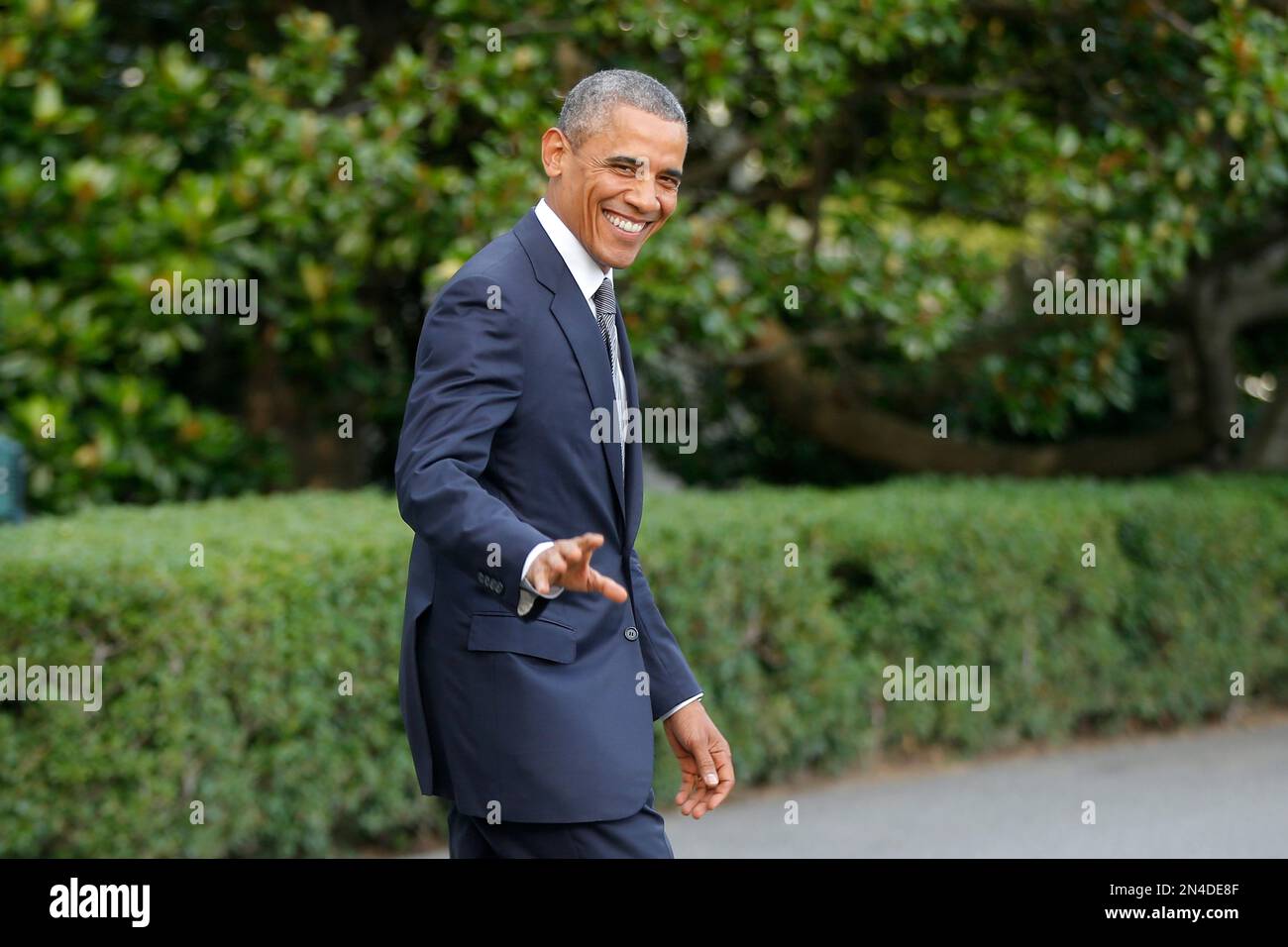 President Barack Obama walks on the South Lawn at the White House in ...