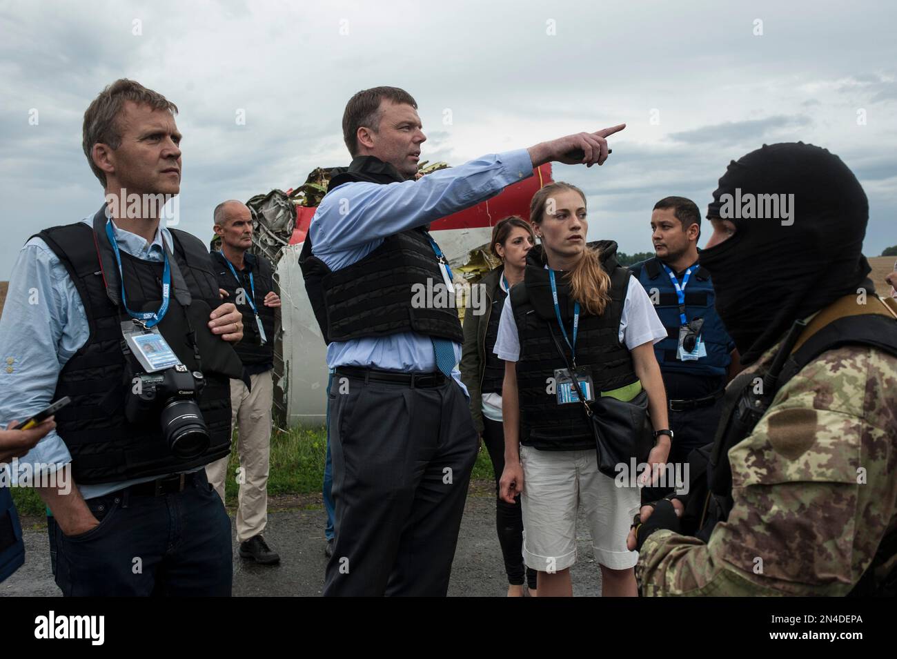 Alexander Hug, deputy head of the OSCE mission, centre, gestures as he ...