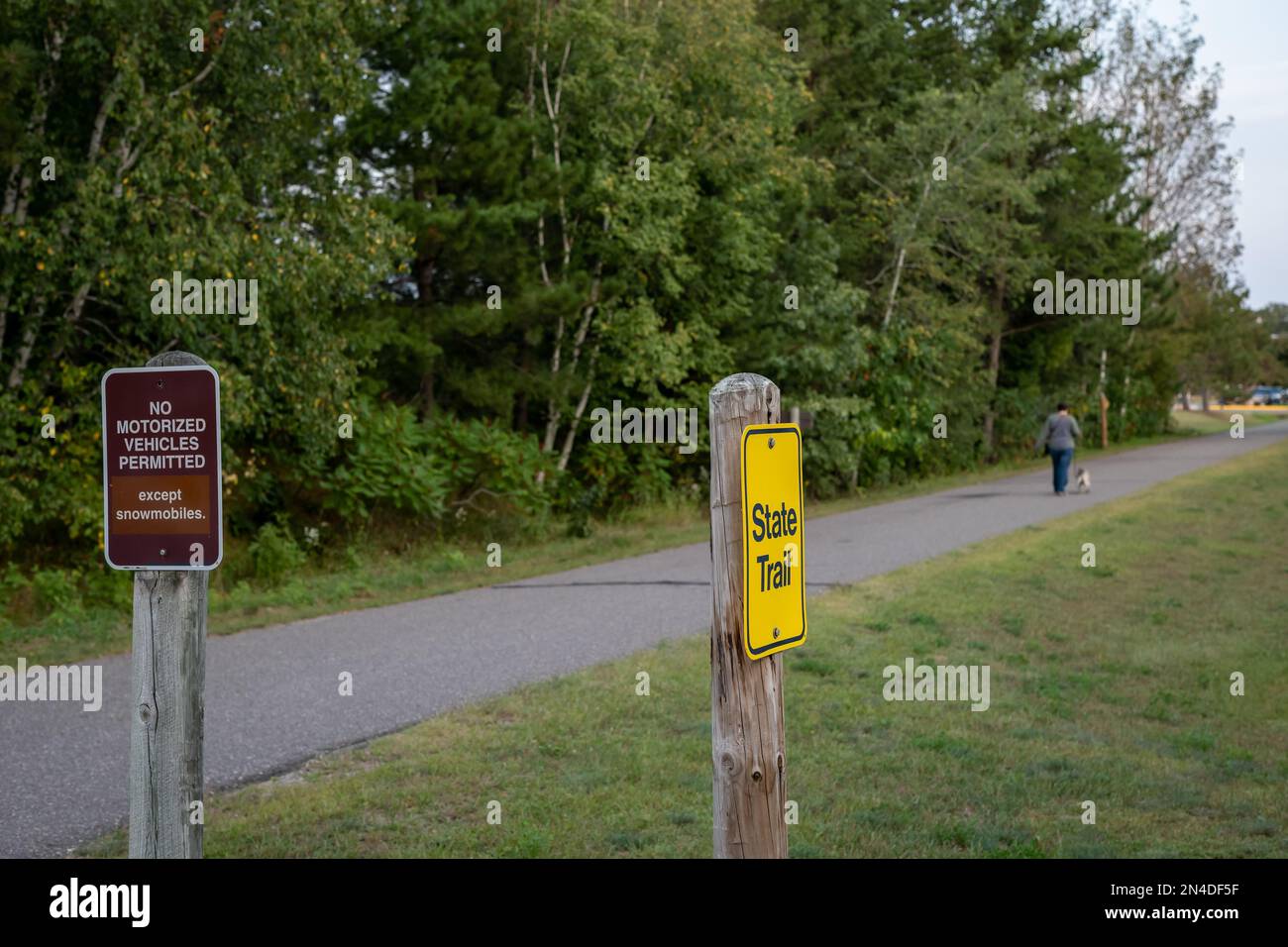 Signs on wooden posts along a paved bicycle, walking and snowmobile ...