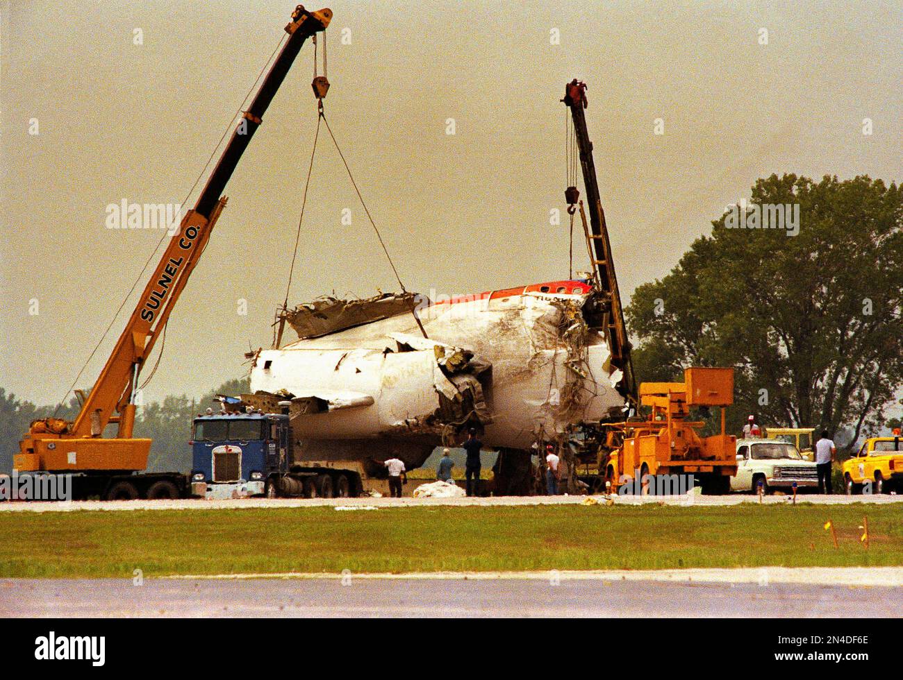 FILE - In this July 22, 1989 file photo cranes lift the tail section of ...