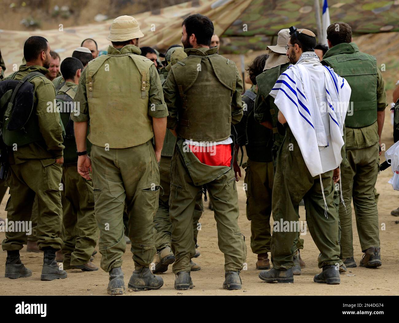 Israeli soldiers gather near the border of Israel and Gaza, Friday ...