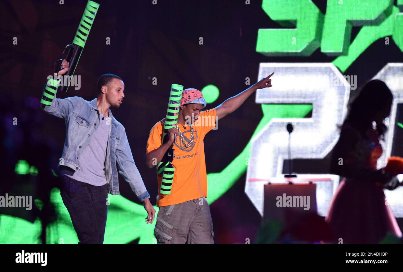 Stephen Curry, left, and Nick Cannon walk on stage to present the ...