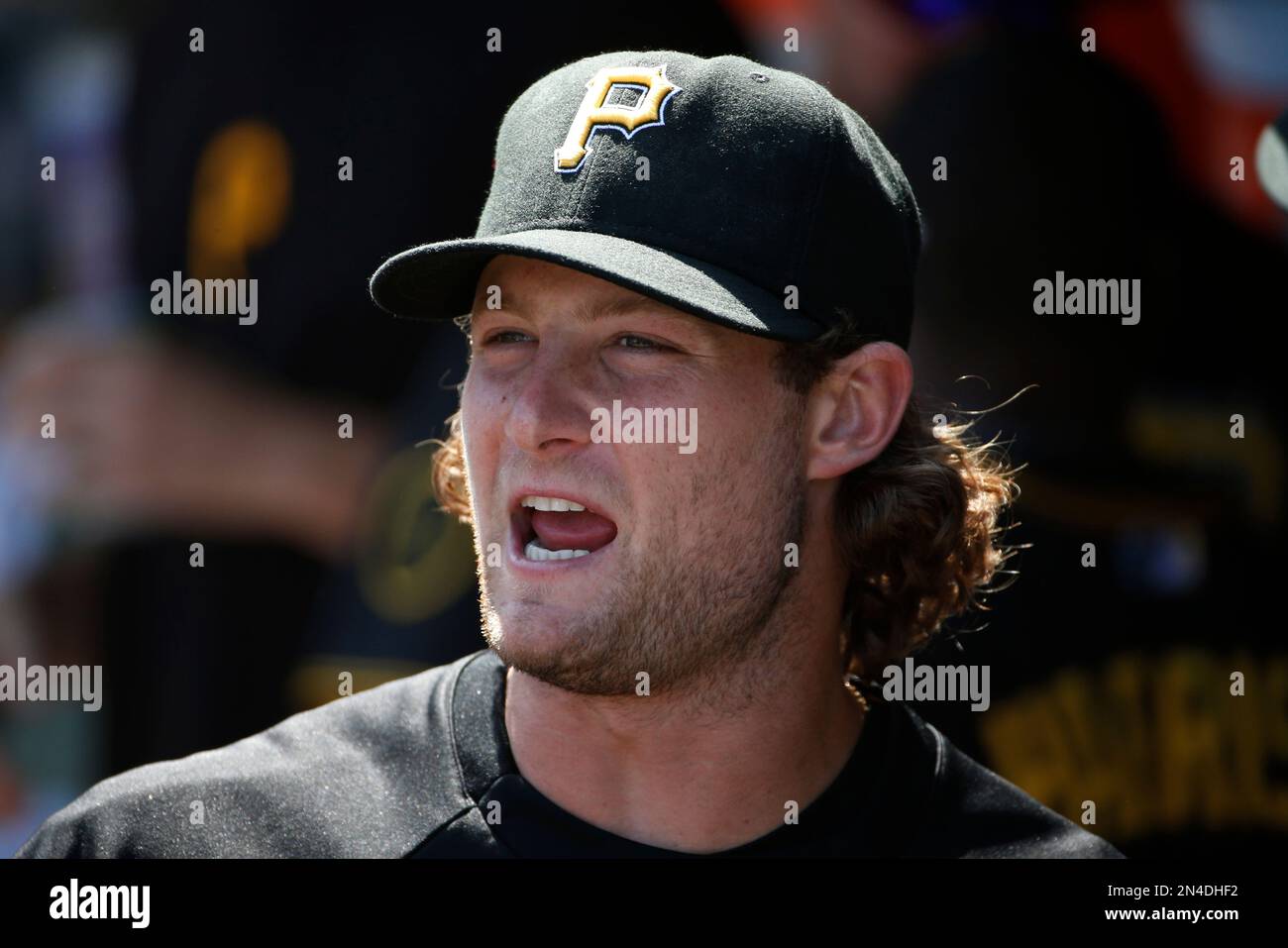 Pittsburgh Pirates' Gerrit Cole stands in the dugout before a baseball ...