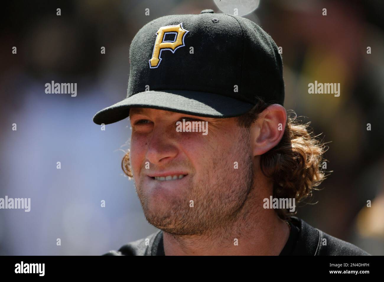Pittsburgh Pirates' Gerrit Cole stands in the dugout before a baseball ...