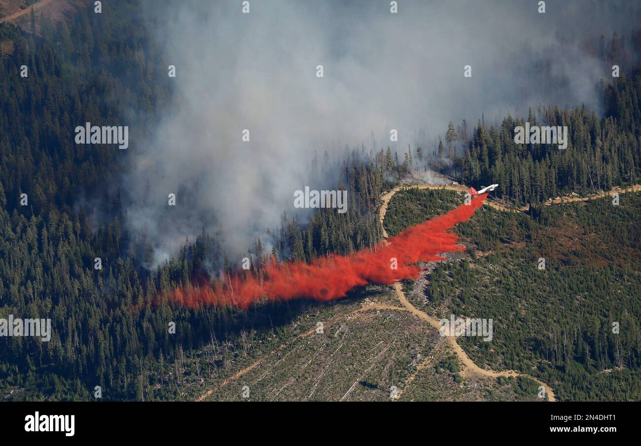 A plane drops fire retardant on the Chiwaukum Creek Fire near ...