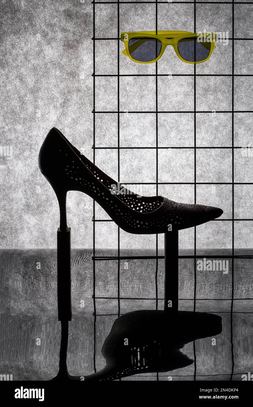 Still life with a woman's high-heeled shoe and glasses Stock Photo - Alamy