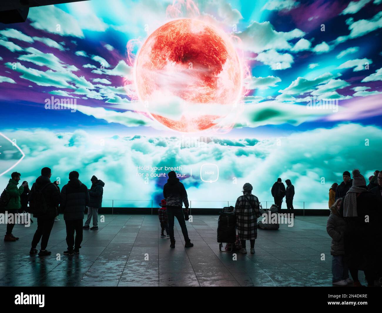 The now building. Members of the public look at huge screens ...