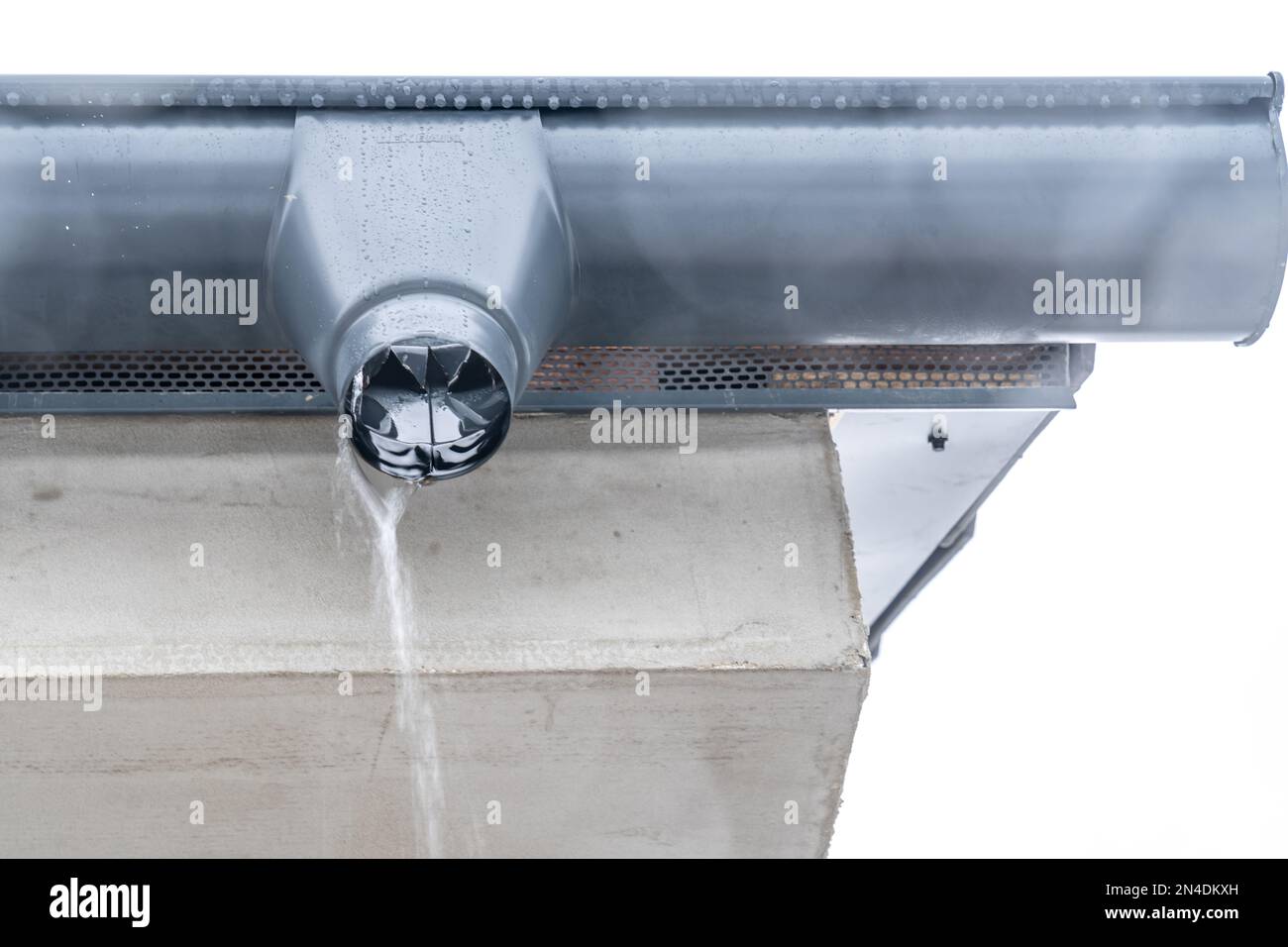 gutter with flowing rainwater on the roof of the building Stock Photo ...
