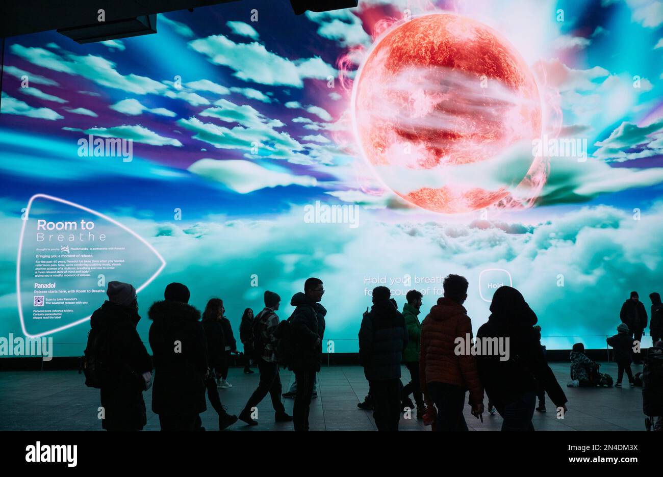 The now building. Members of the public look at huge screens ...