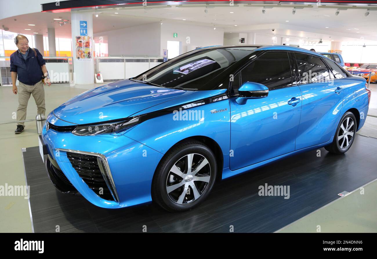 In this June 26, 2014 photo, a visitor looks at Toyota Motor's new fuel ...