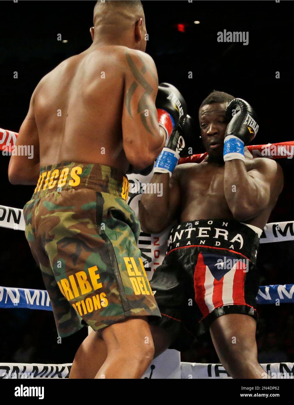 Yuniel Dorticos, left, and Edison Miranda fight during a boxing match ...