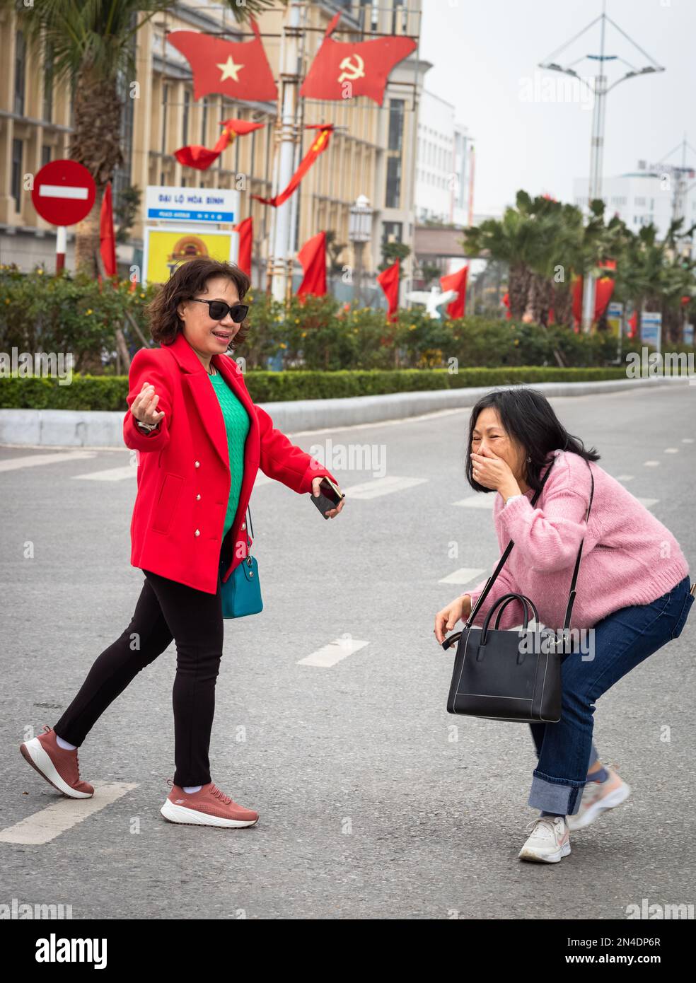 Two Vietnamese domestic tourists laugh as they pose for a photo in Mong ...