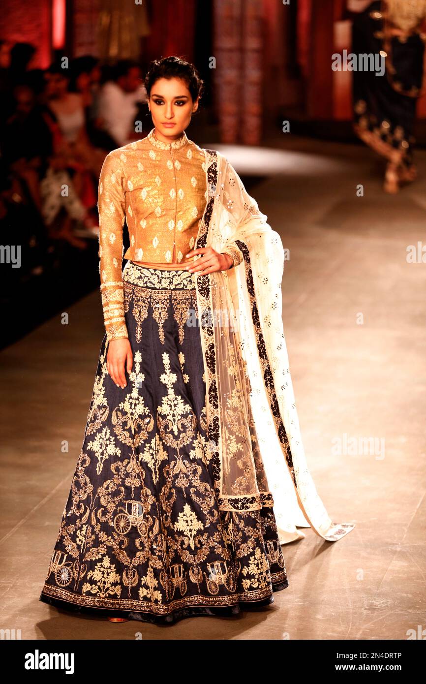 A model displays a dress created by Indian designer Anju Modi at the ...