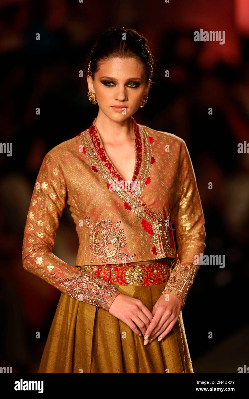 A model displays a dress created by Indian designer Anju Modi at the ...