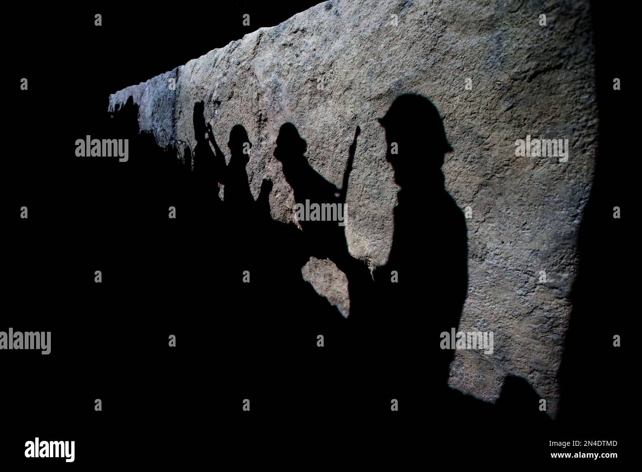 Silhouettes of British soldiers are projected onto a trench scene in ...