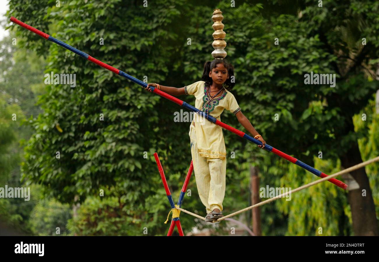 An Indian street performer Shanti, 8, walks a tightrope in Allahabad ...