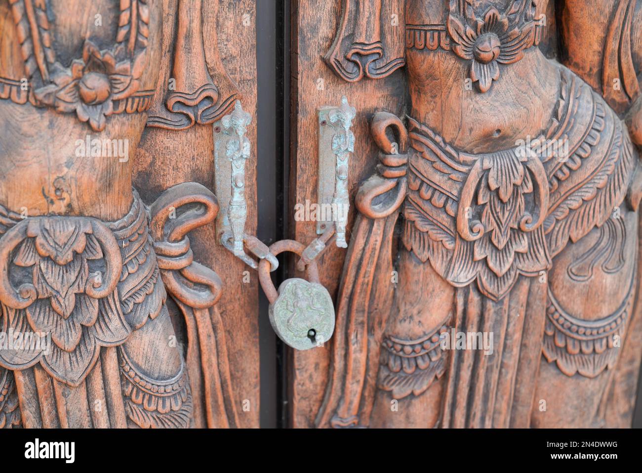 carved wooden door closed by an old ancient padlock with key ancient ...
