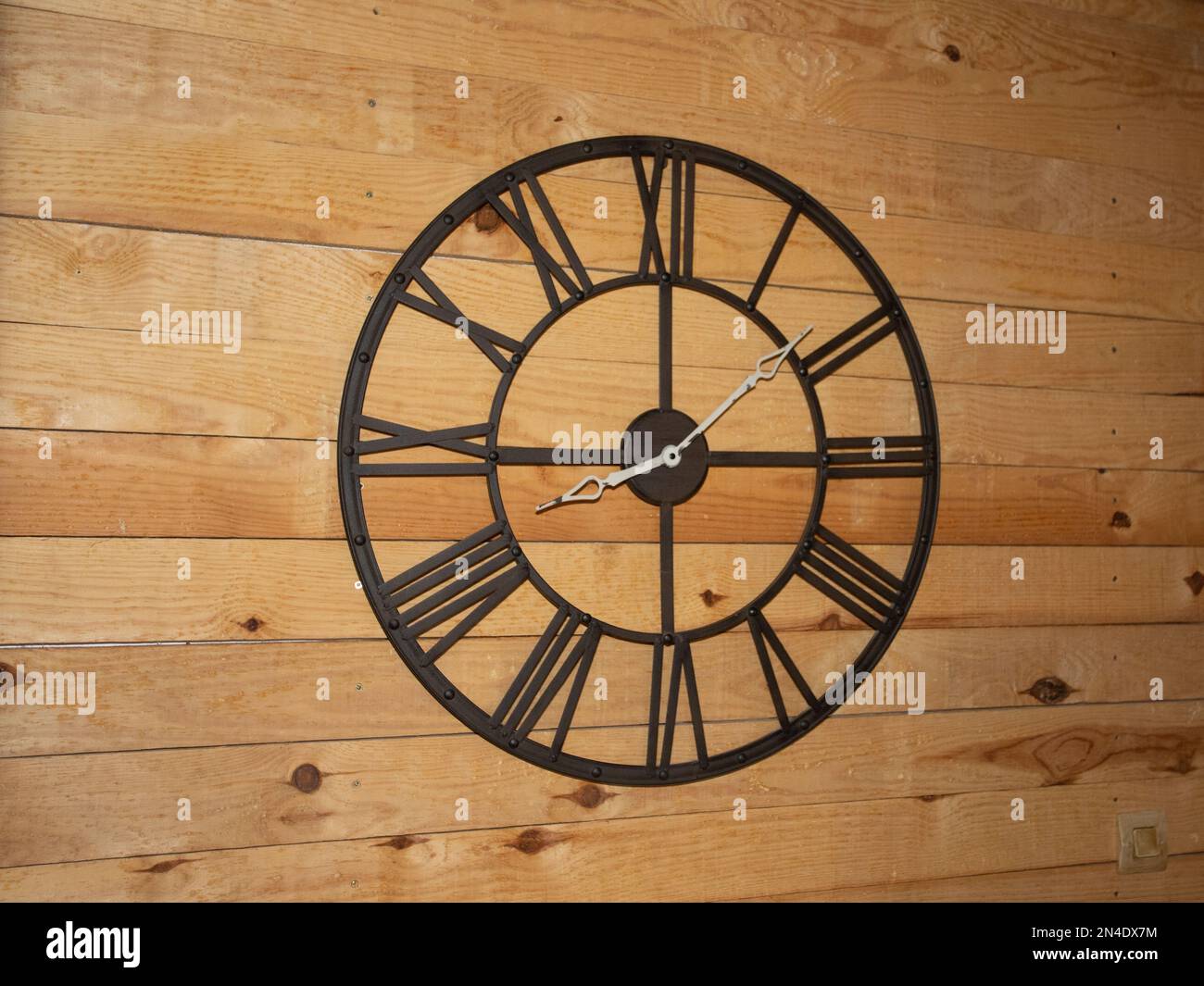 Vintage black steel Old big roman numerals Clock in wooden wall home ...