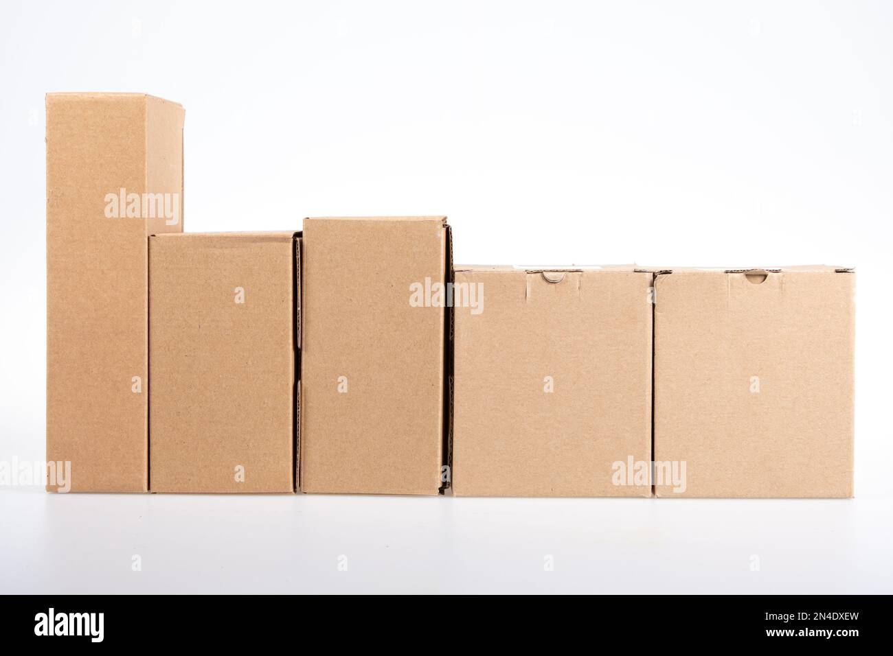 many brown used cardboard boxes on white background Stock Photo - Alamy