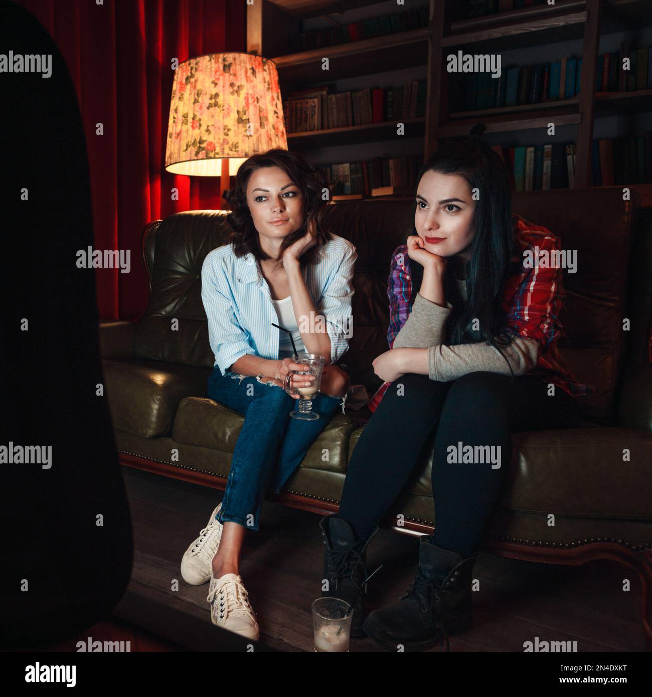 Beautiful young girls watch tv, fun entertainment Stock Photo - Alamy