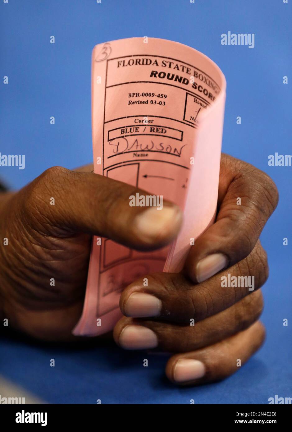 A boxing judge holds a scorecard before the start of a boxing match ...