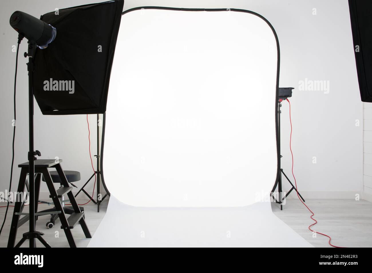 photo studio with the flashes and the projector and a white background ...
