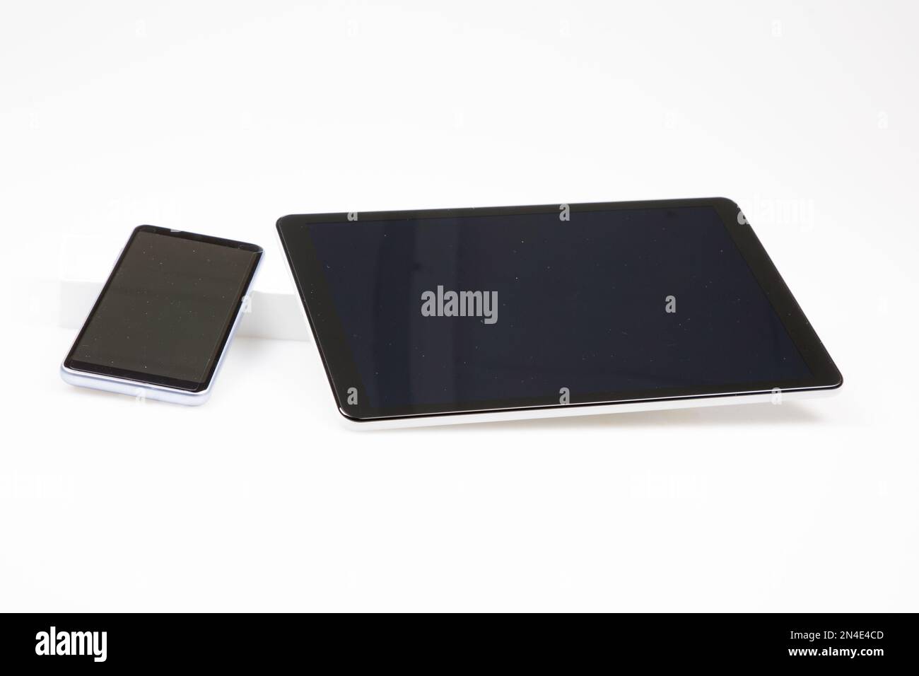 tablet computer in landscape orientation and smartphone in portrait ...