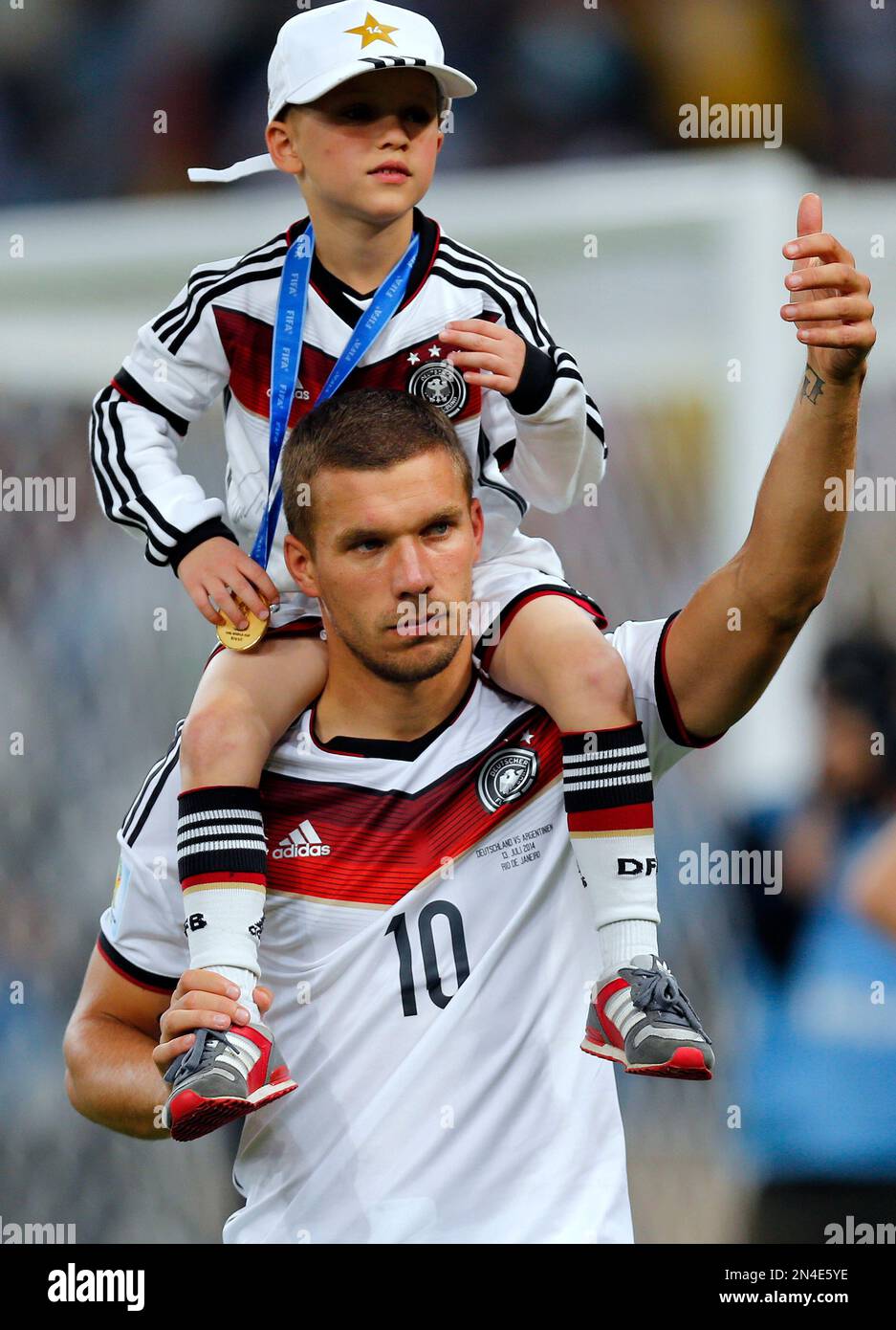 Germany's Lukas Podolski carries his son Louis Gabriel after the World ...
