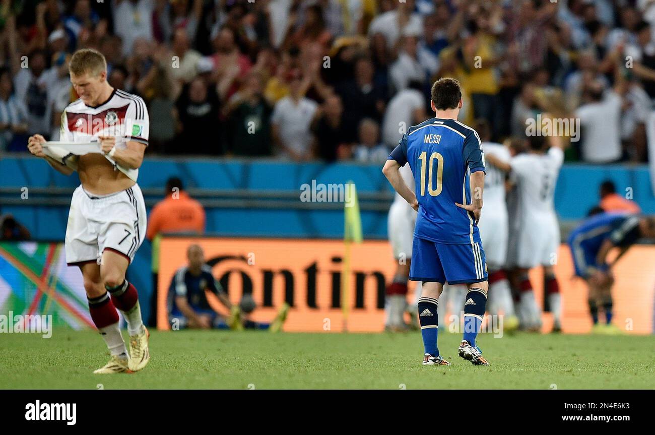 Argentina's Lionel Messi (10) stands on the pitch and Germany's Bastian ...
