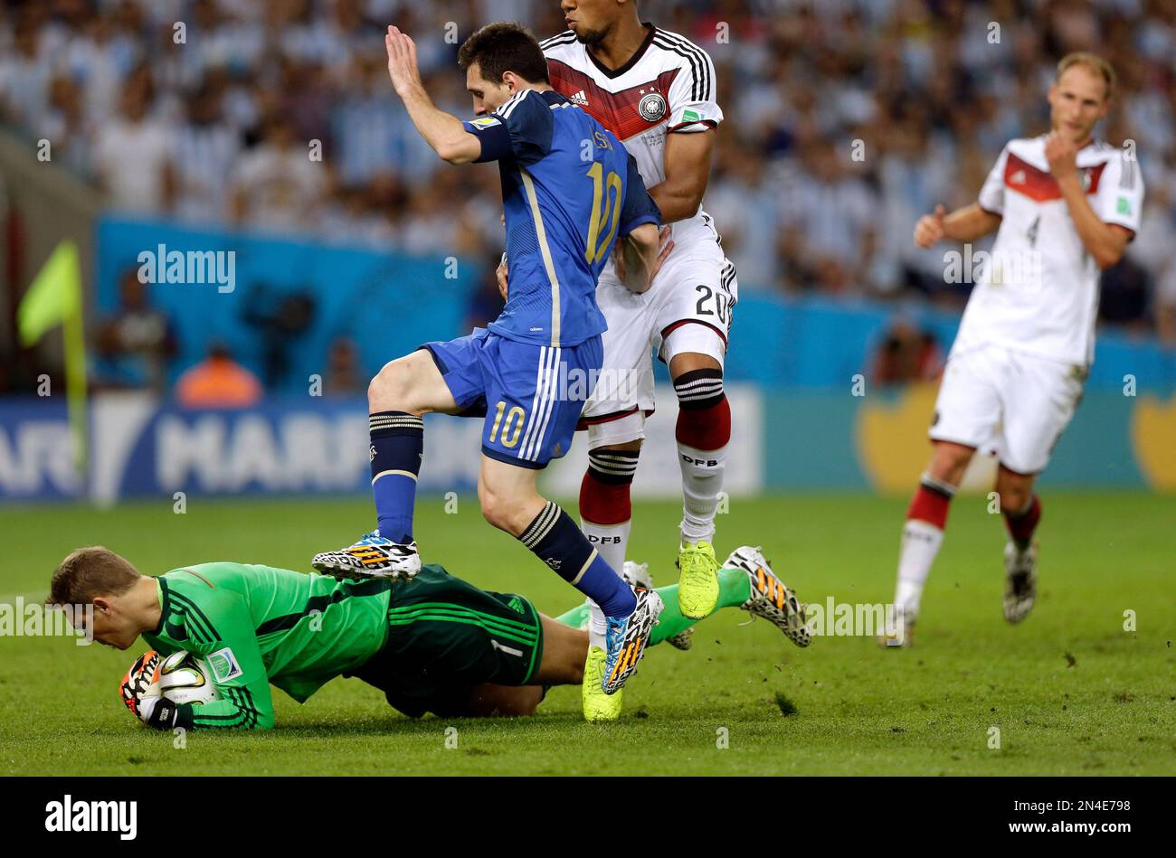 Germany's goalkeeper Manuel Neuer, bottom saves a ball by Argentina's ...