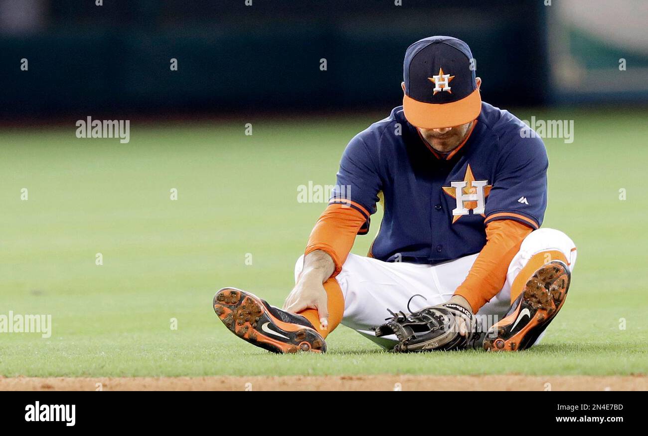 Houston Astros second baseman Jose Altuve hangs his head after committing a throwing error that ...