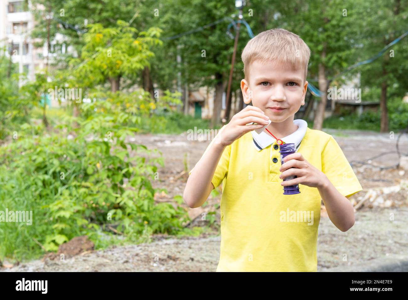 Happy little boy have fun blowing colorful shiny rainbow bubbles ...