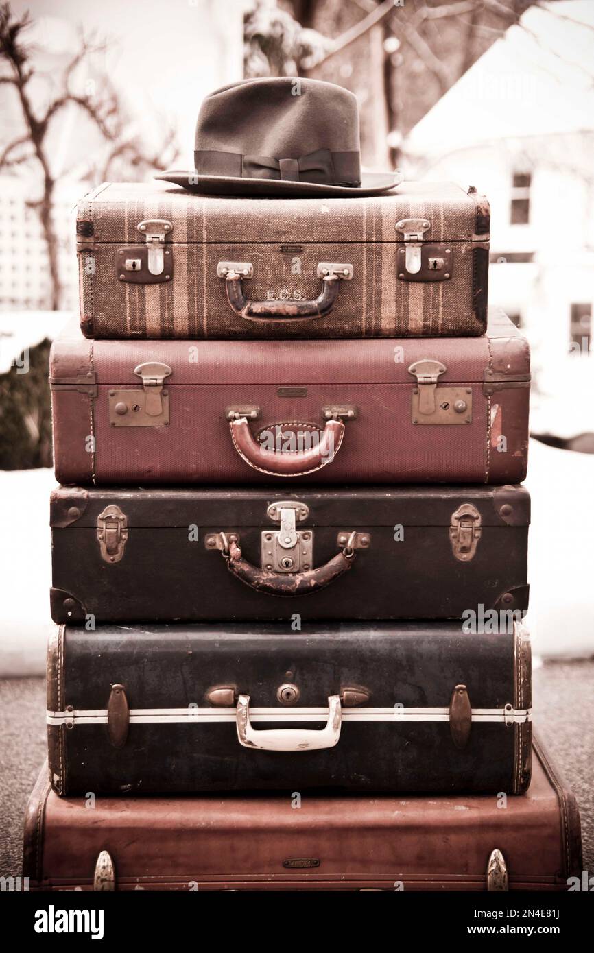 Stack of Vintage Suitcases with a Fedora Hat Stock Photo - Alamy