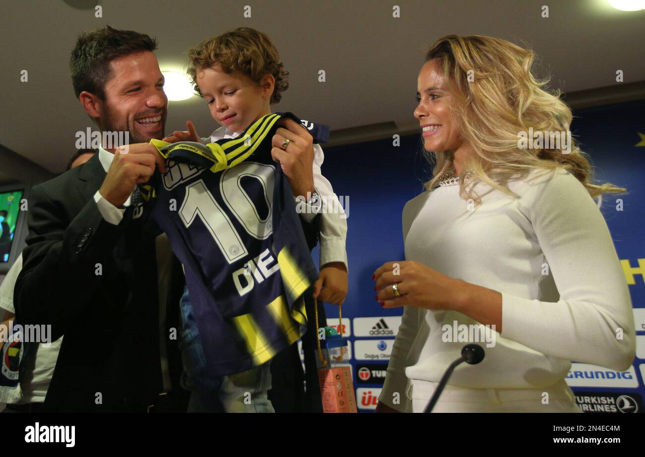 Brazilian soccer star Diego Ribas, left, holds his new jersey with his ...