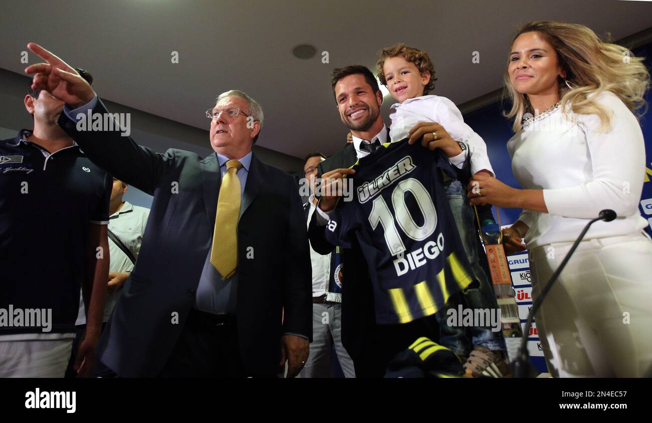 Brazilian soccer star Diego Ribas holds his new jersey with his son ...