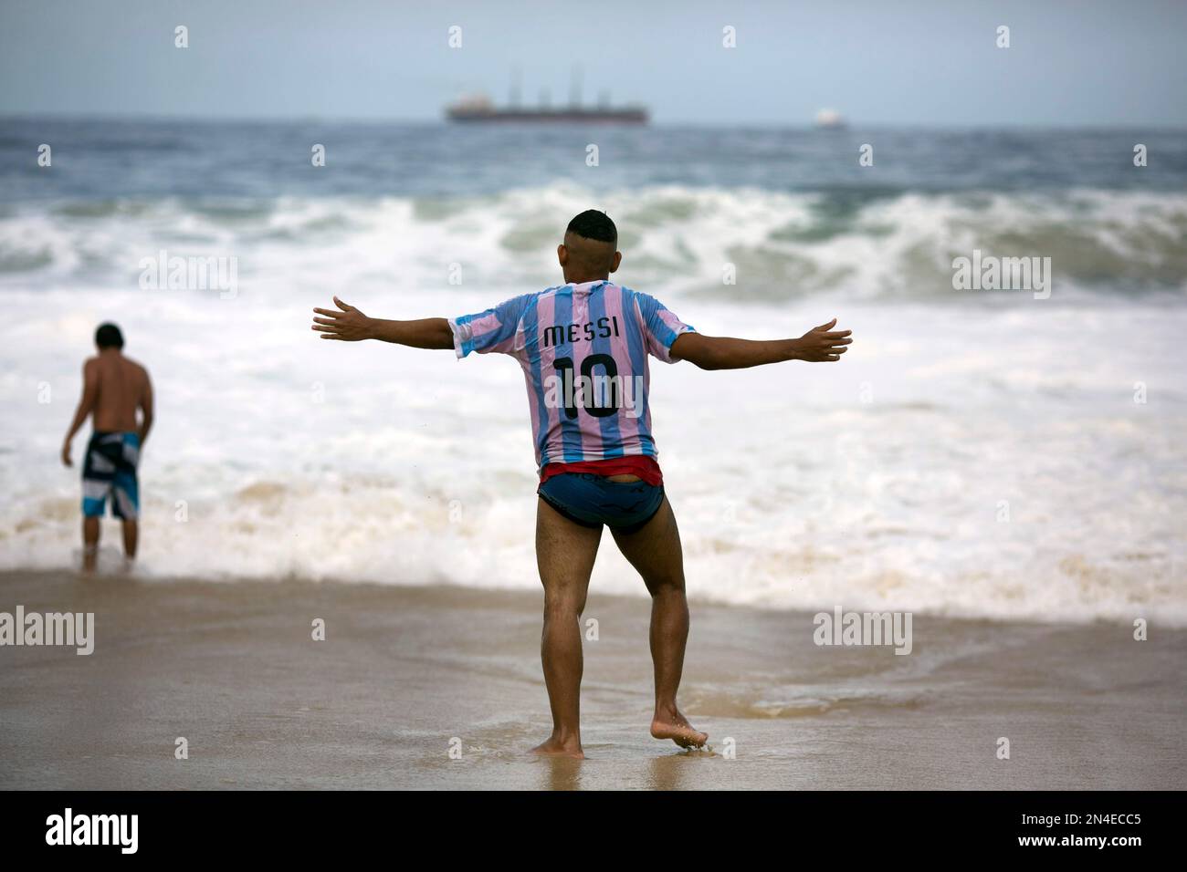 An Argentina soccer fan wearing a Lionel Messi soccer T-shirt stands on ...