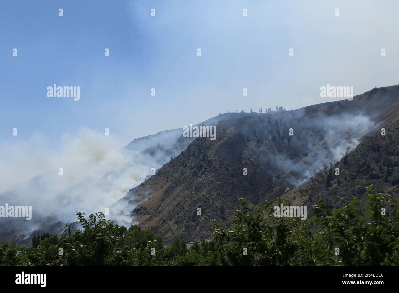 Smoke rises from the area of a wildfire near Entiat, Wash., Friday ...