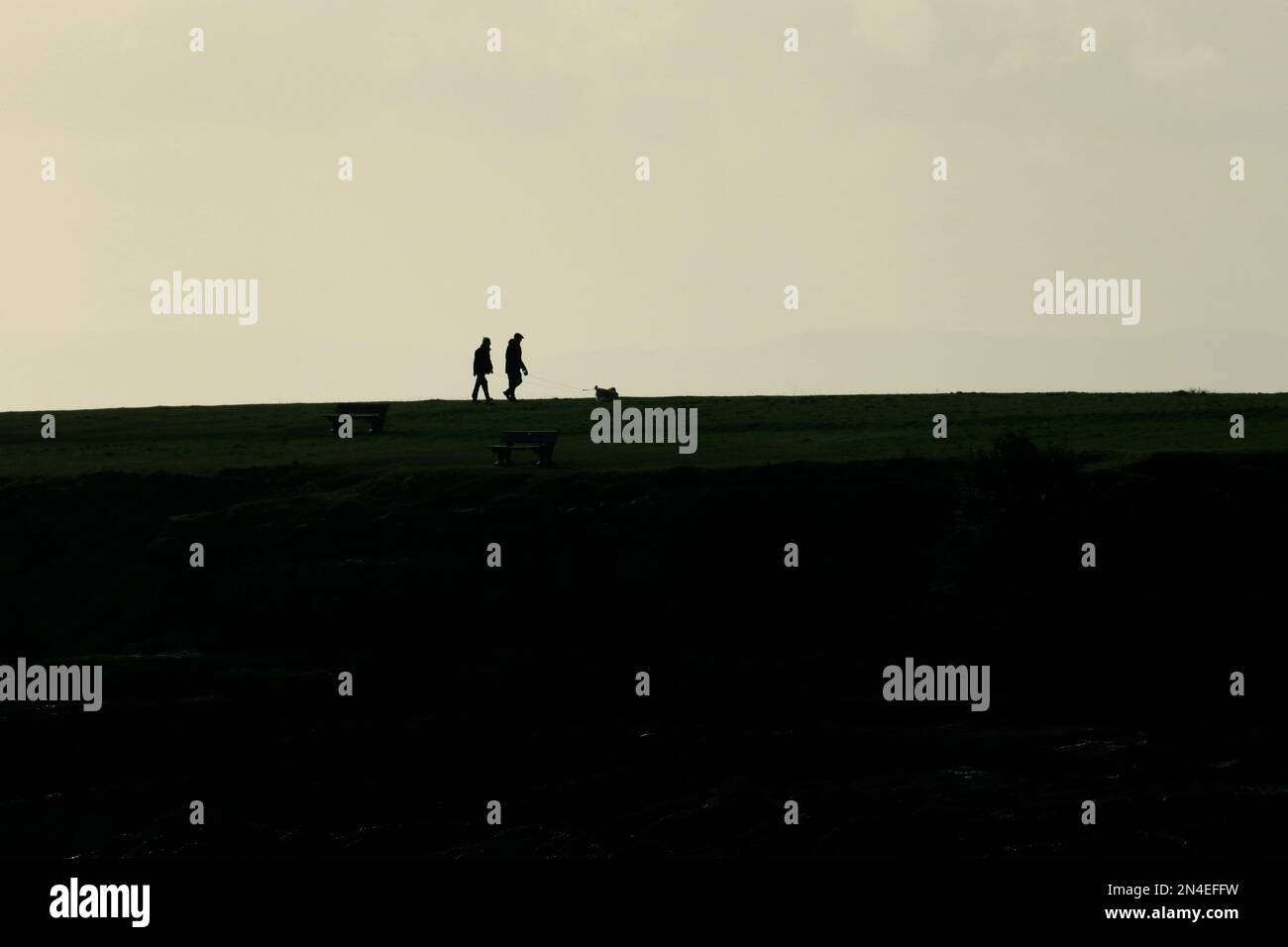 Couple walking dog on Friars Point, Barry Island, South Wales Stock ...