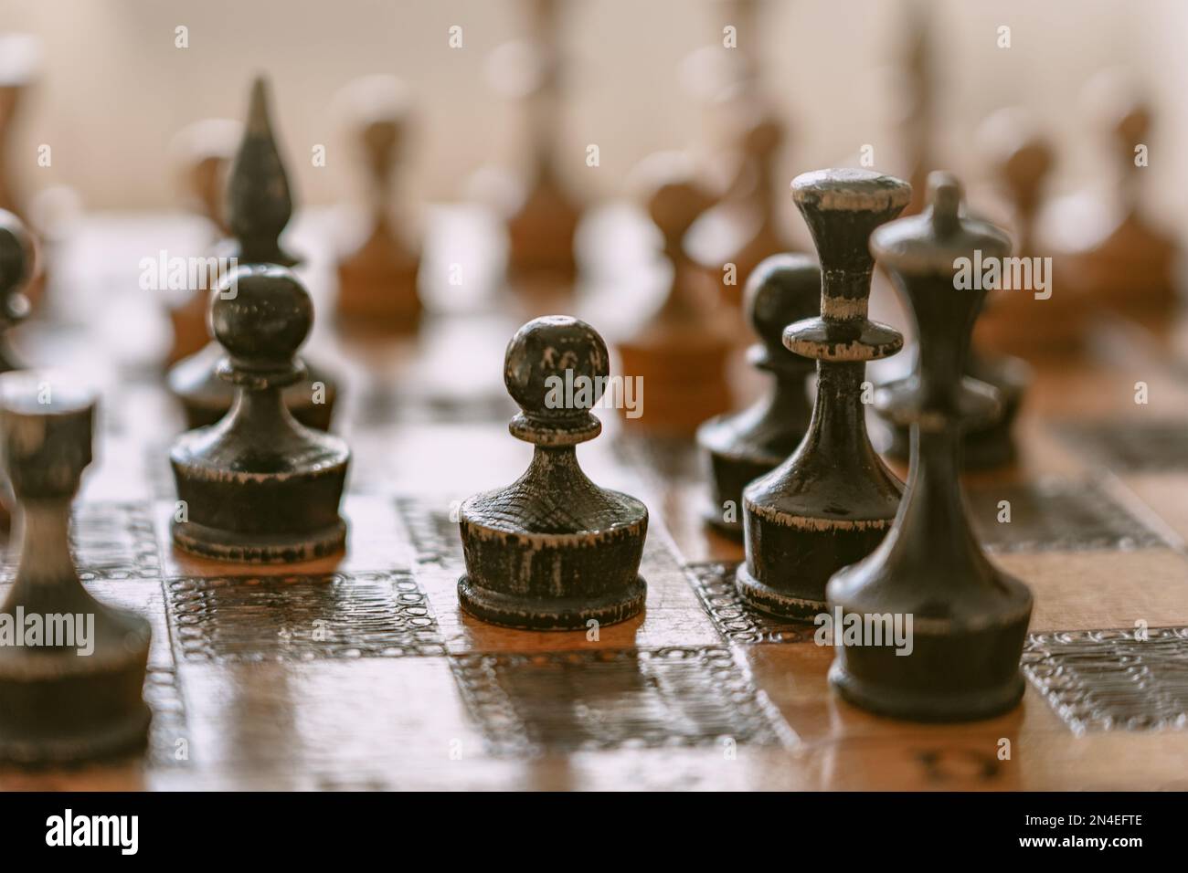 pawn and other figures on the vintage old chess board Stock Photo - Alamy