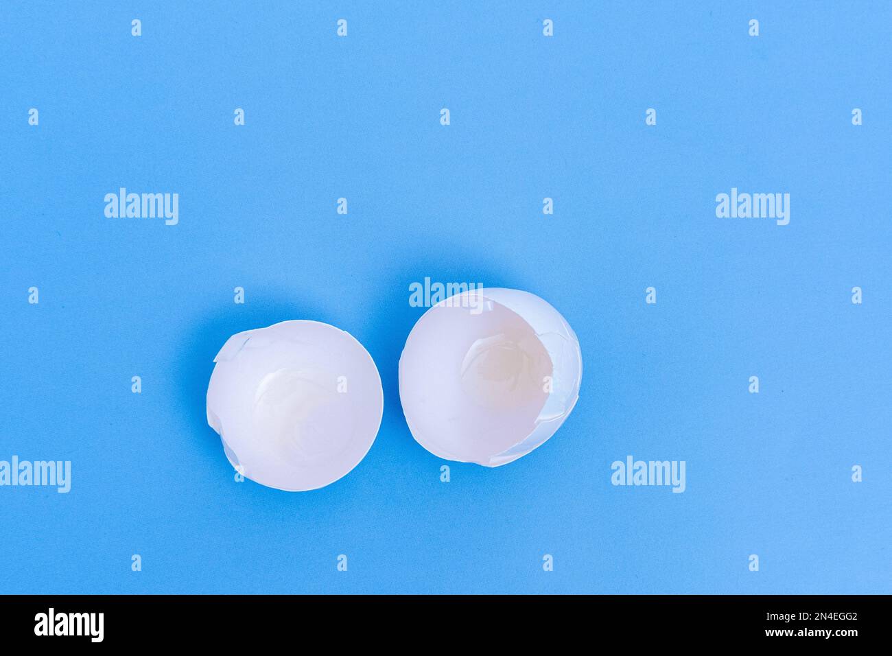 One white broken egg shell on blue background. Breaking out of the ...