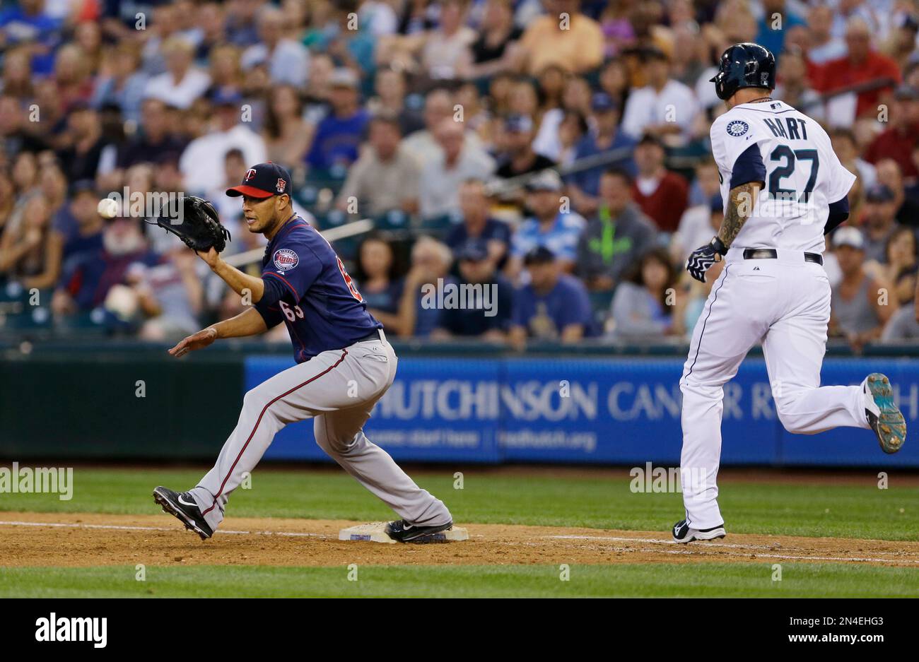 Minnesota Twins starting pitcher Yohan Pino, left, catches the throw to ...