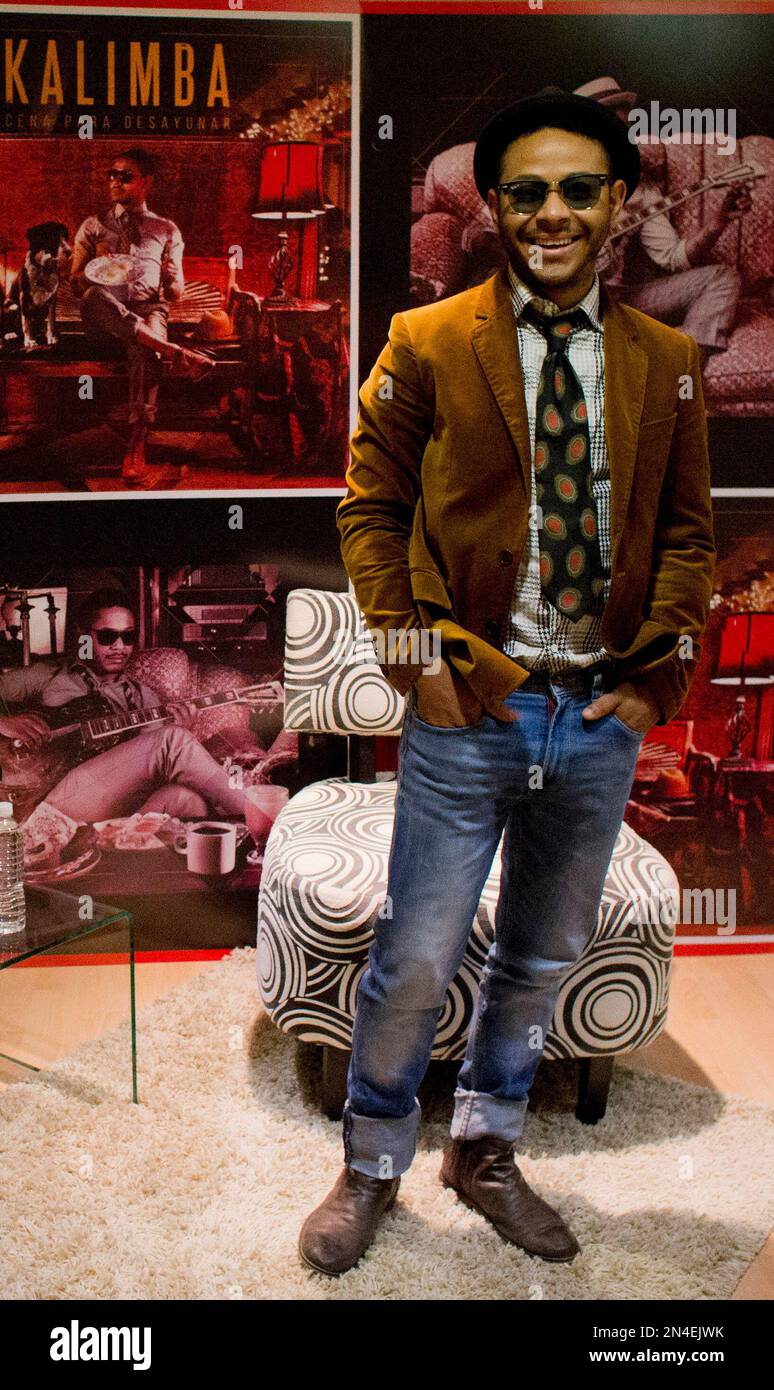 Kalimba stands in front of a backdrop featuring artwork from his new ...