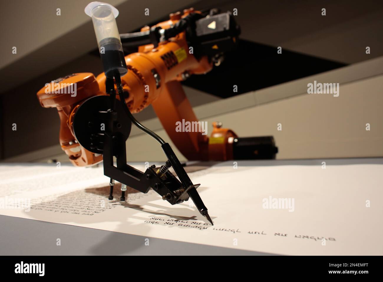 A robot writes a Torah at an installation in the Jewish Museum in ...
