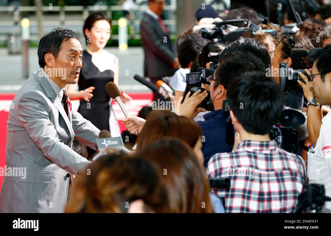 Japanese actor Ken Watanabe answers a reporter's question during the ...