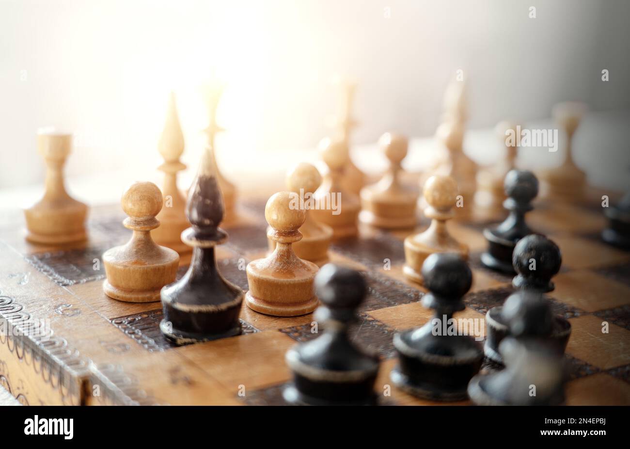 pawn and other figures on the vintage old chess board Stock Photo - Alamy
