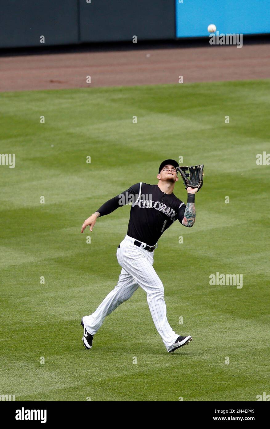 Colorado Rockies right fielder Brandon Barnes eyes the final out ...