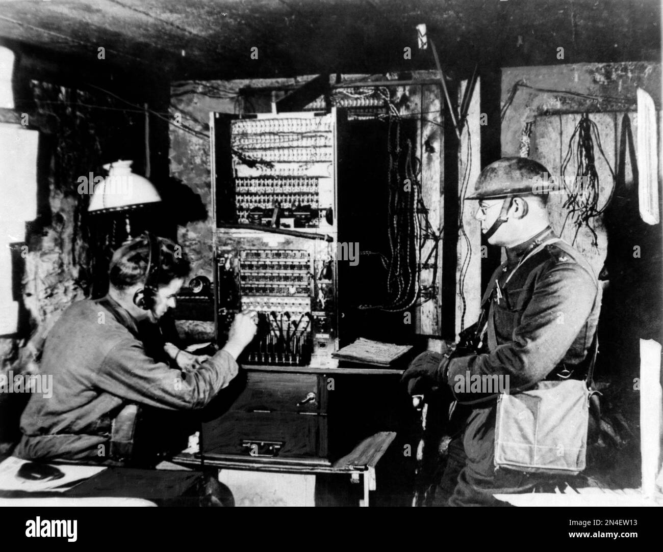U.S. soldiers operate a radio switchboard in a dugout just behind the front line trenches during ...