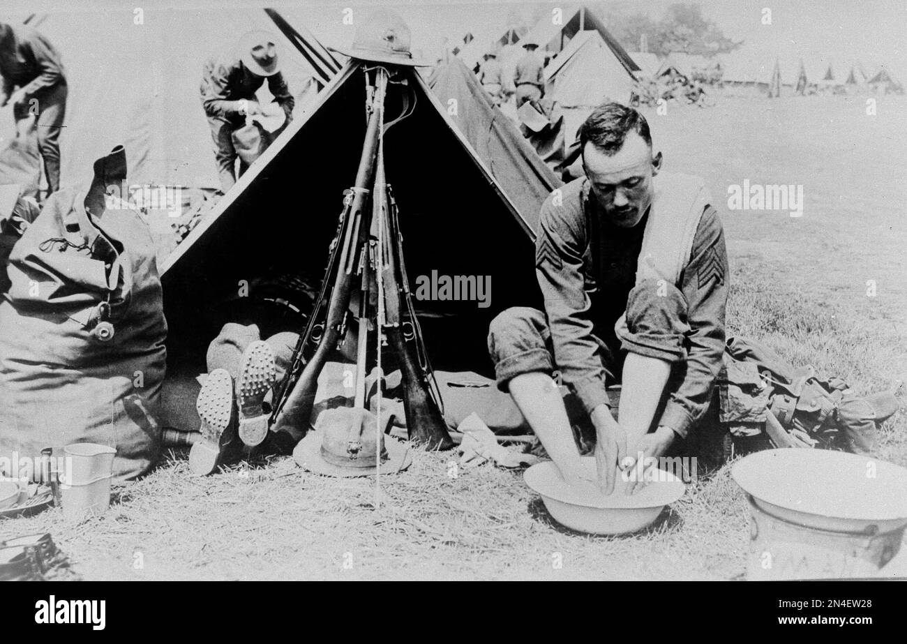 A U.S. Marine prepares for his next foot inspection after a long day of ...