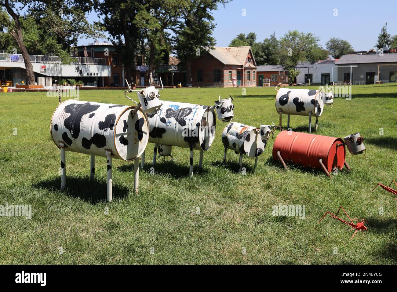 A cows handmade craft made of metal barrels in a garden in Erqi factory ...