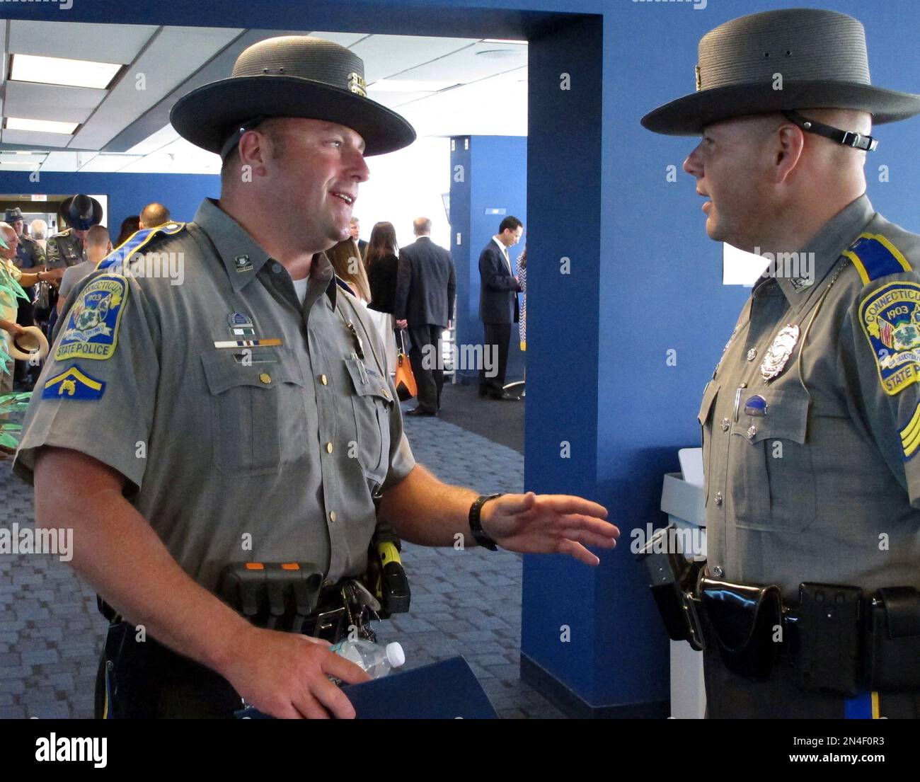 Connecticut state Trooper First Class Matthew Bell, left, talks with ...